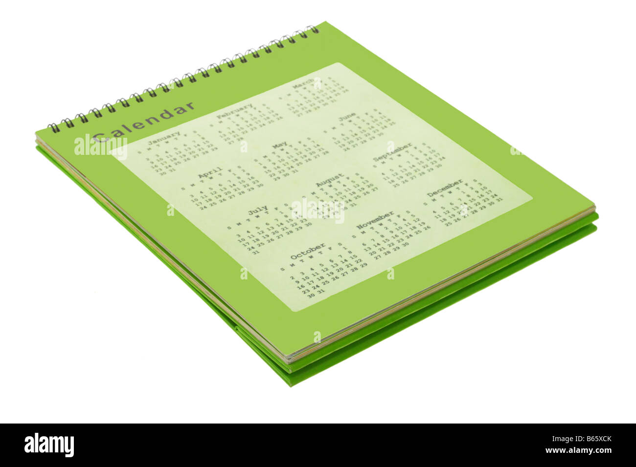 Green desktop calendar isolated on white background Stock Photo - Alamy