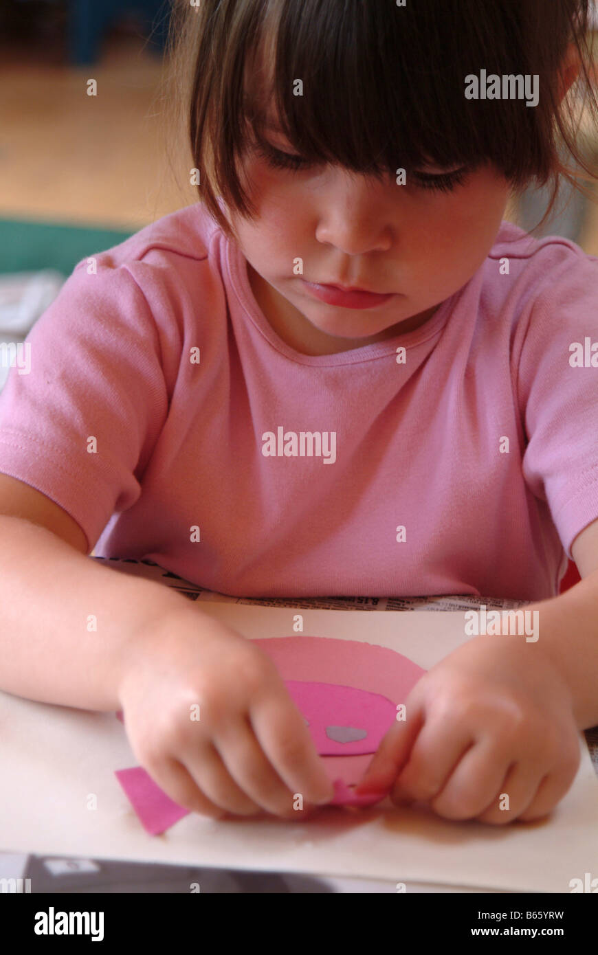 Little girl making a picture out of shapes at nursery Stock Photo - Alamy