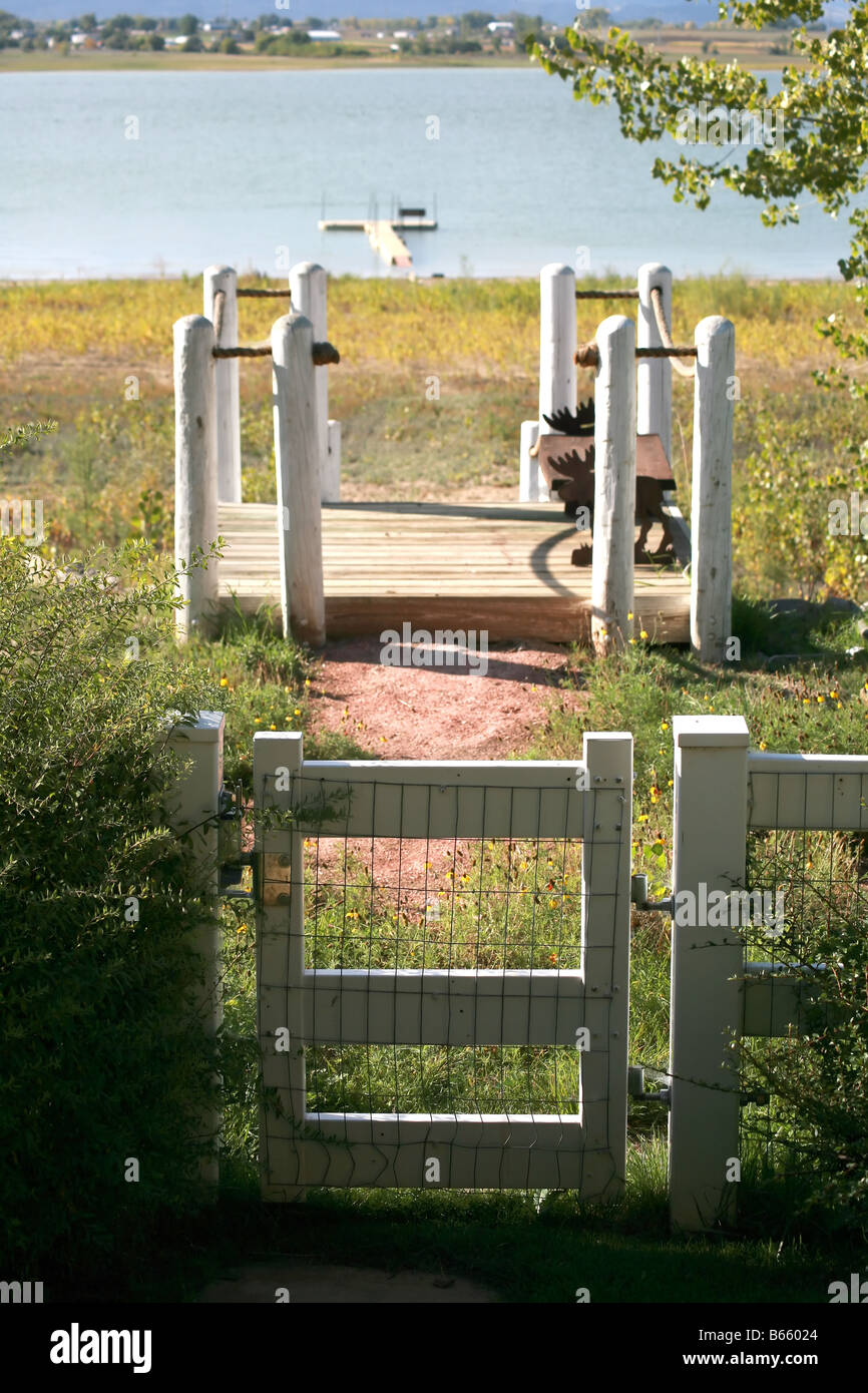 Gate to a path leading to the lake Stock Photo - Alamy