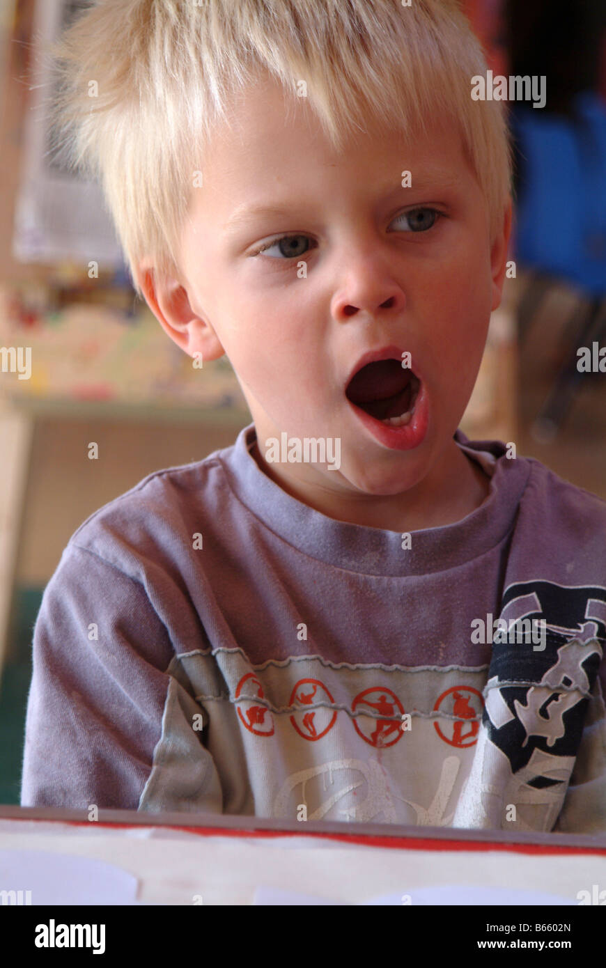 Little boy yawning Stock Photo - Alamy
