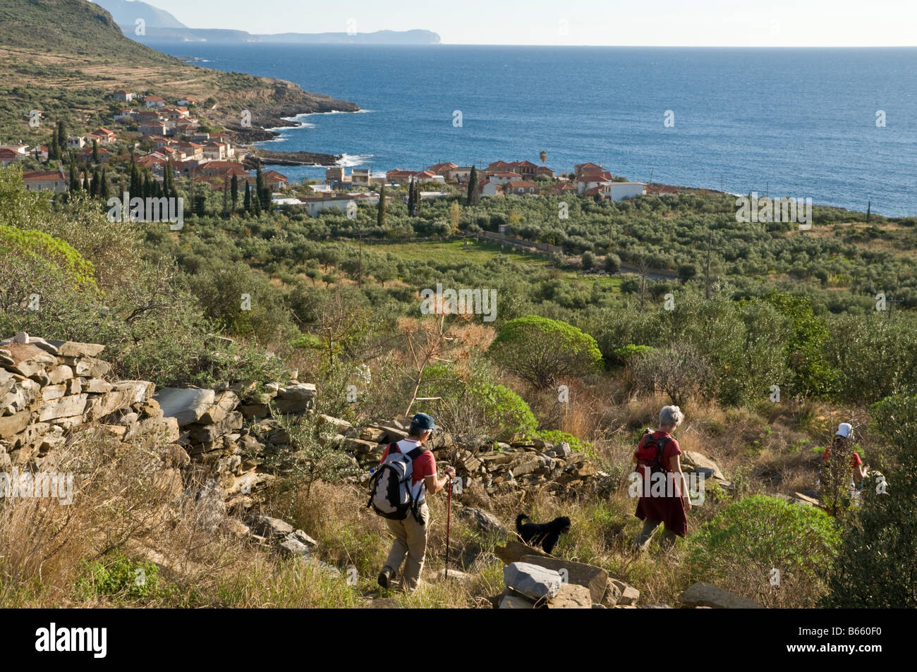 Walkers on an old kalderimi stone path above Trachila on the Mani coast ...