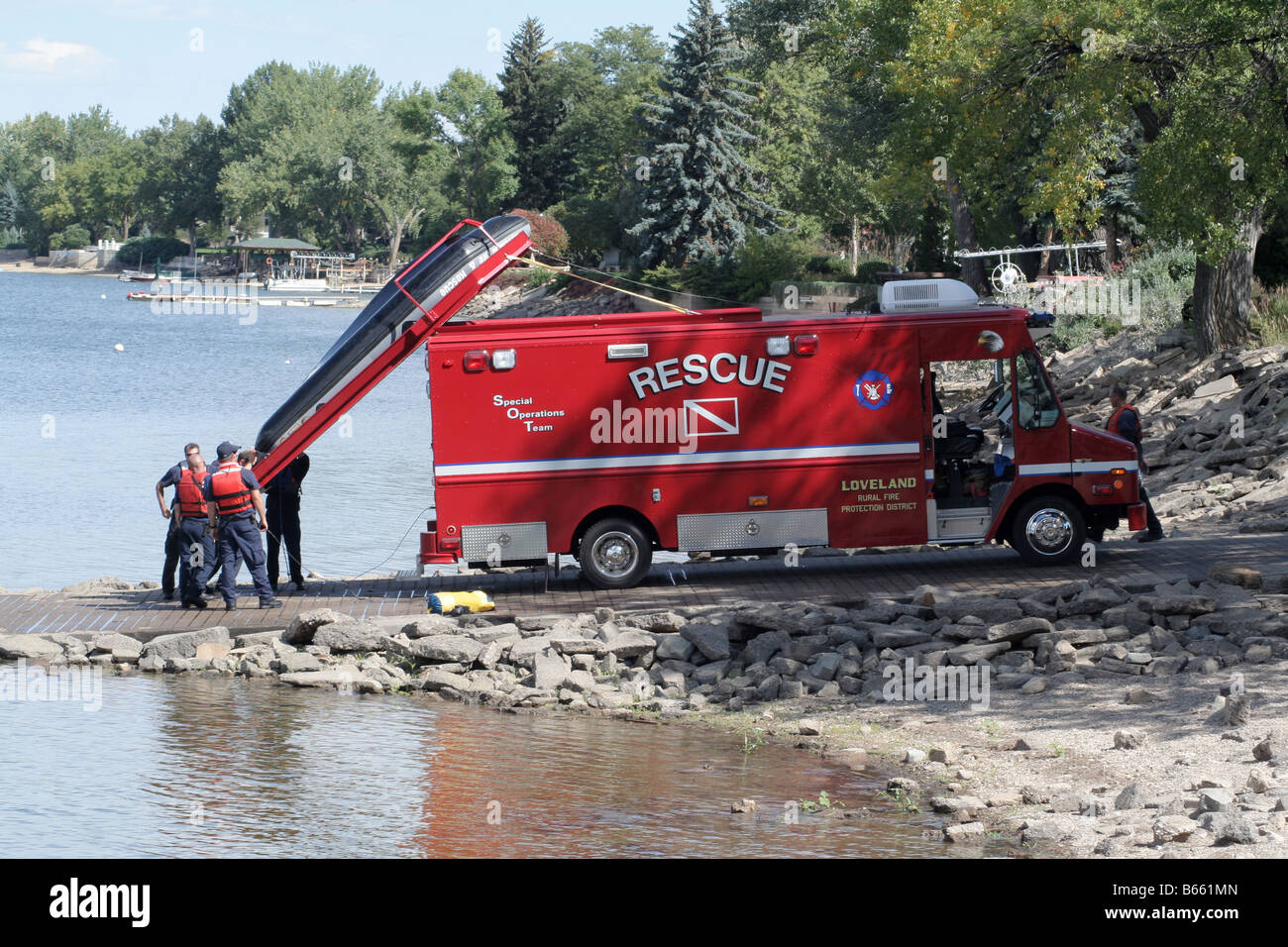 Water rescue team loading dingy on their truck Stock Photo - Alamy