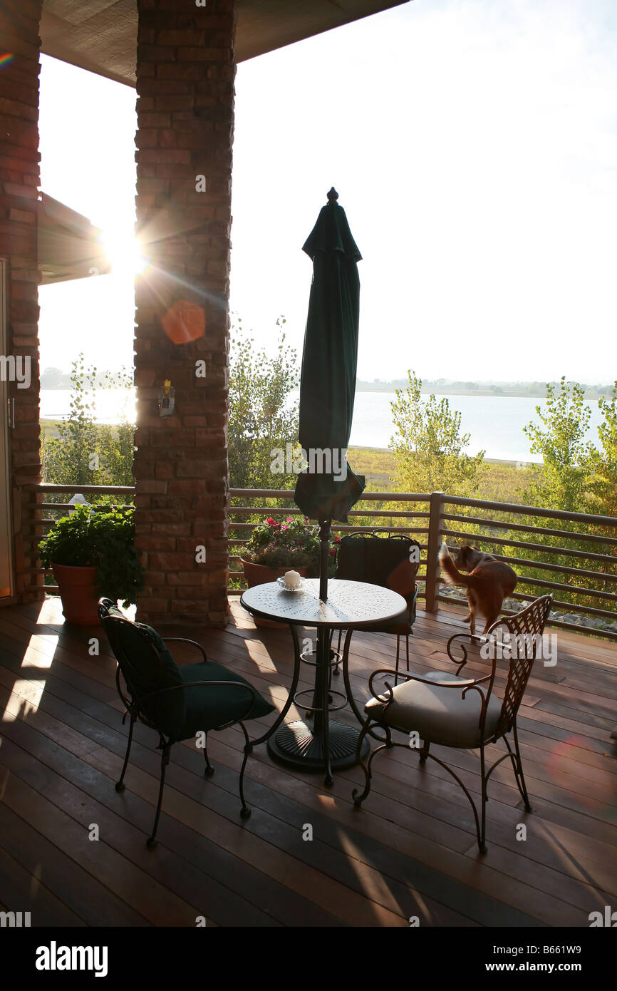 A table and chairs at sunset on a deck Stock Photo - Alamy