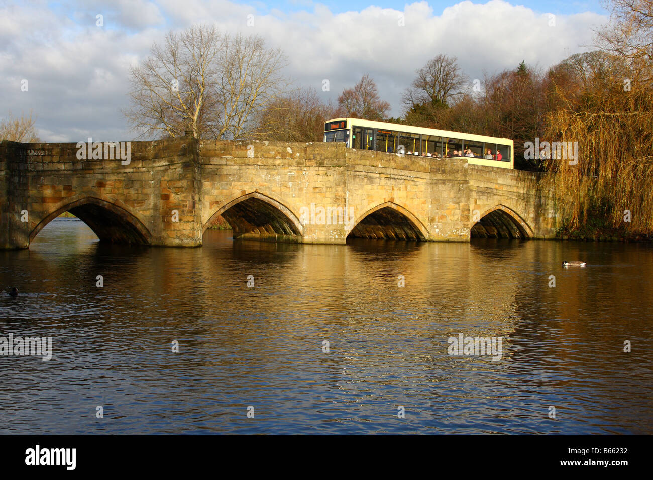 A rural bus service crossing a narrow bridge over the River Wye at ...