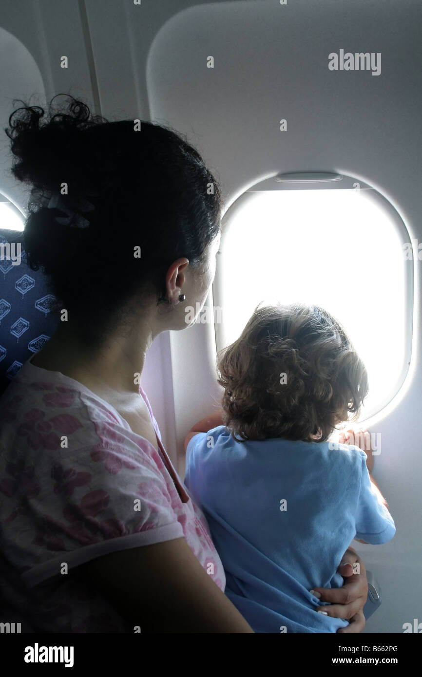 A Mother and her Child Looking out an Airplane Window Stock Photo - Alamy