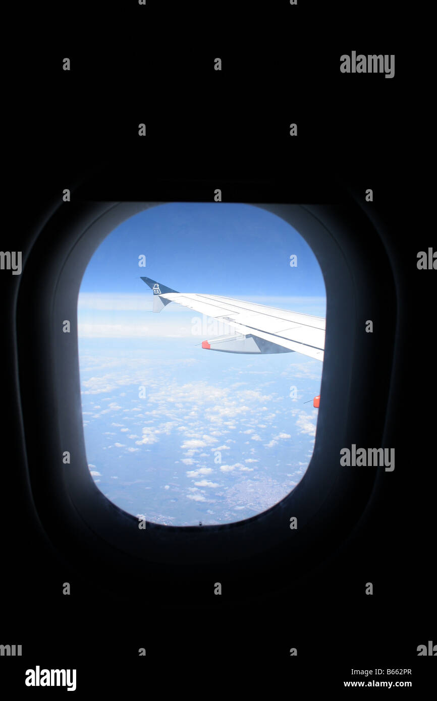 Looking out of an airplane window at the wing and sky Stock Photo - Alamy