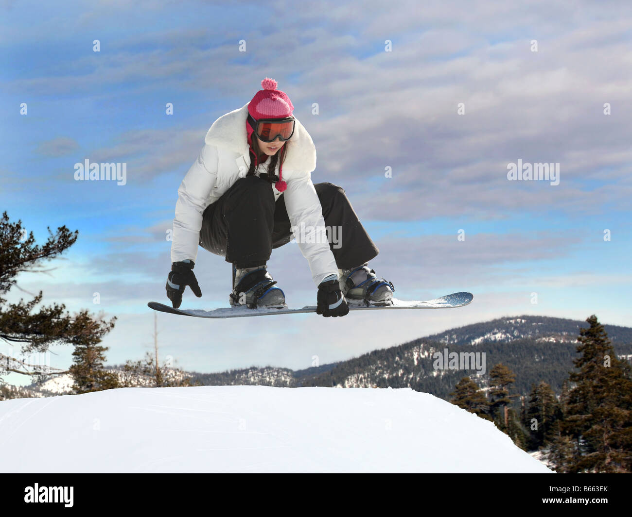 Young mexican girl jumping on a snowboard Stock Photo - Alamy
