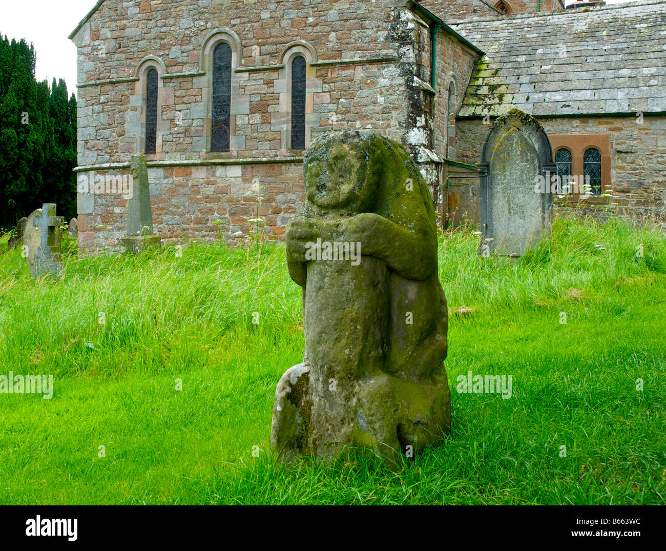 Carved stone bear, one of four in the churchyard of St Andrew's Church ...