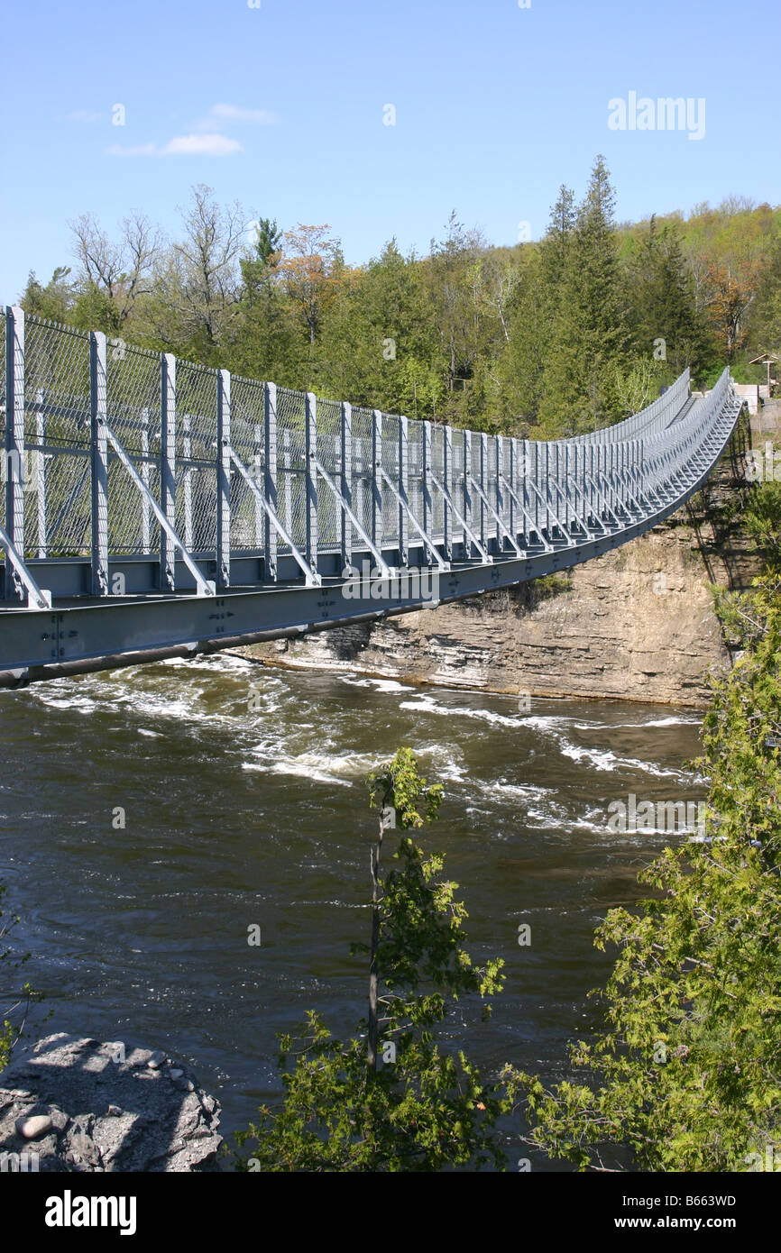 A suspension foot-bridge above rapids on the Ranney River, Ferris ...