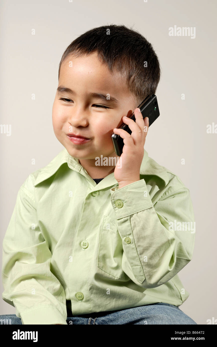 A young cute boy talking on phone Stock Photo - Alamy