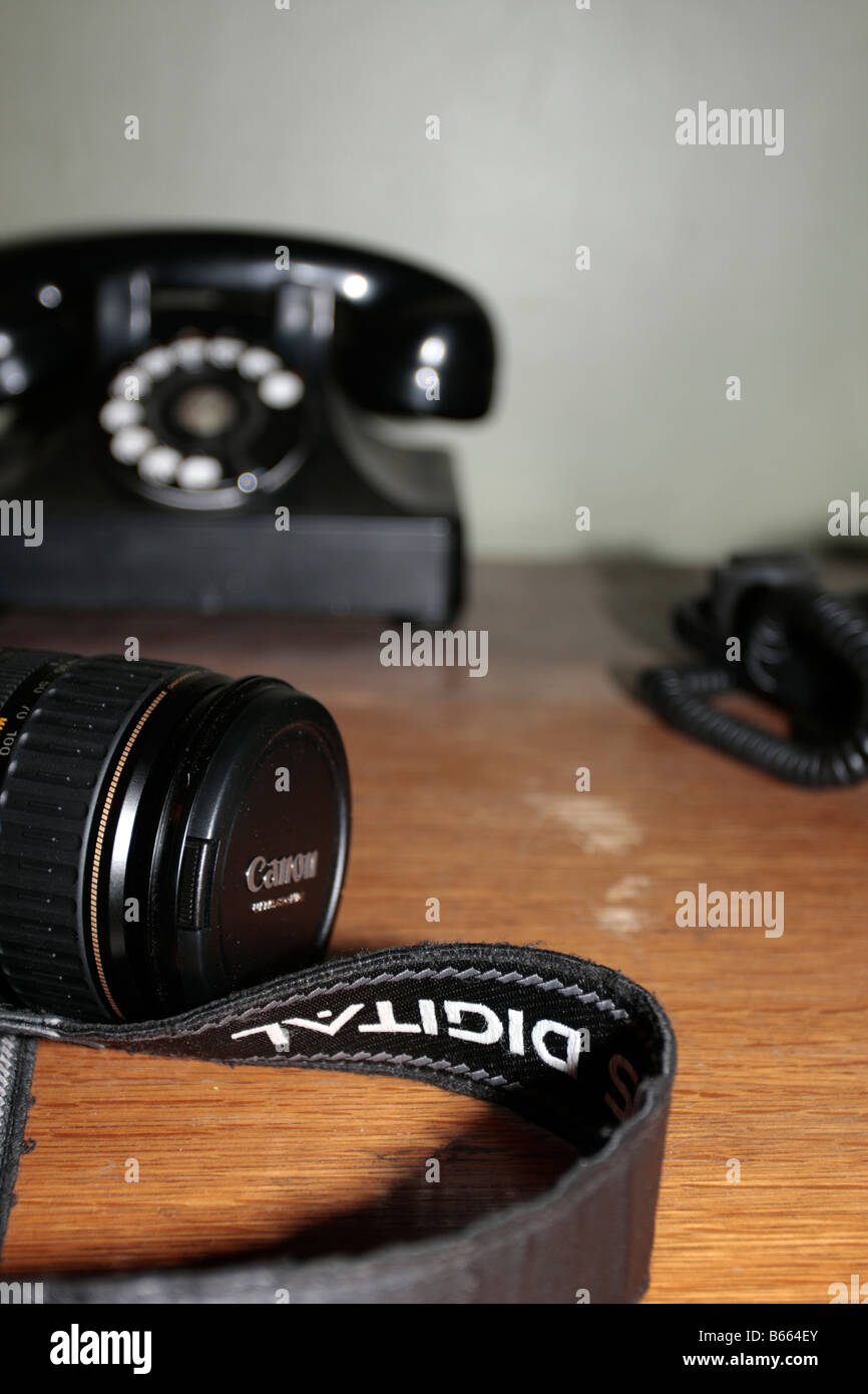 Rotary-dial telephone and lens end on wood Stock Photo - Alamy