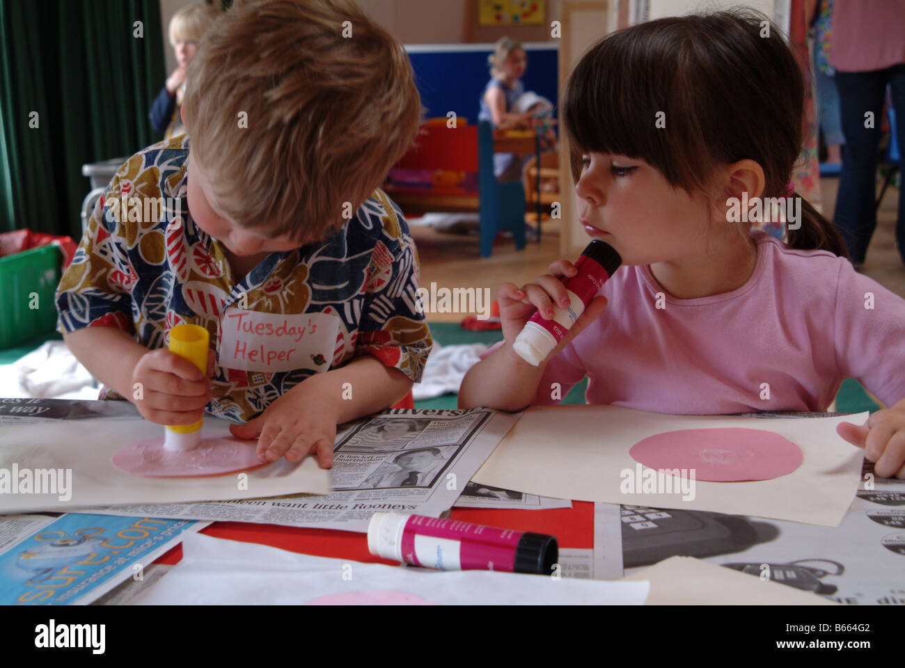 Children glueing pictures at nursery Stock Photo - Alamy