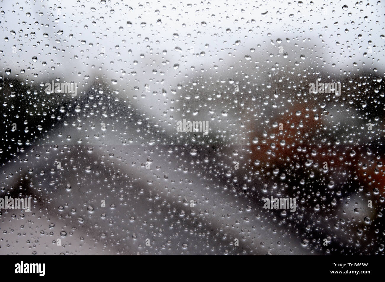 A view of a rooftop through a rain splattered window Stock Photo - Alamy