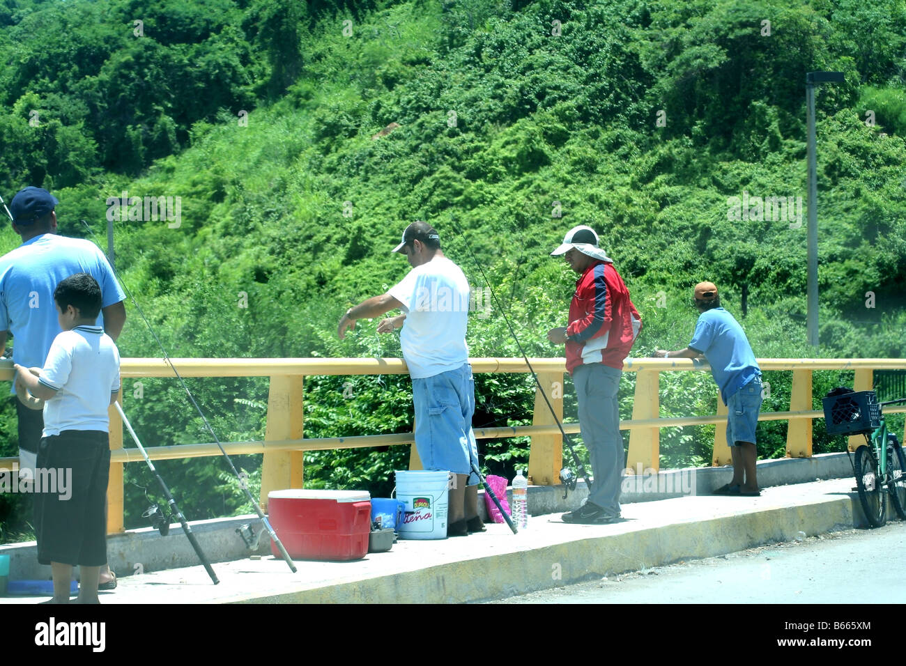 People fishing off of a bridge in Mexico Stock Photo - Alamy