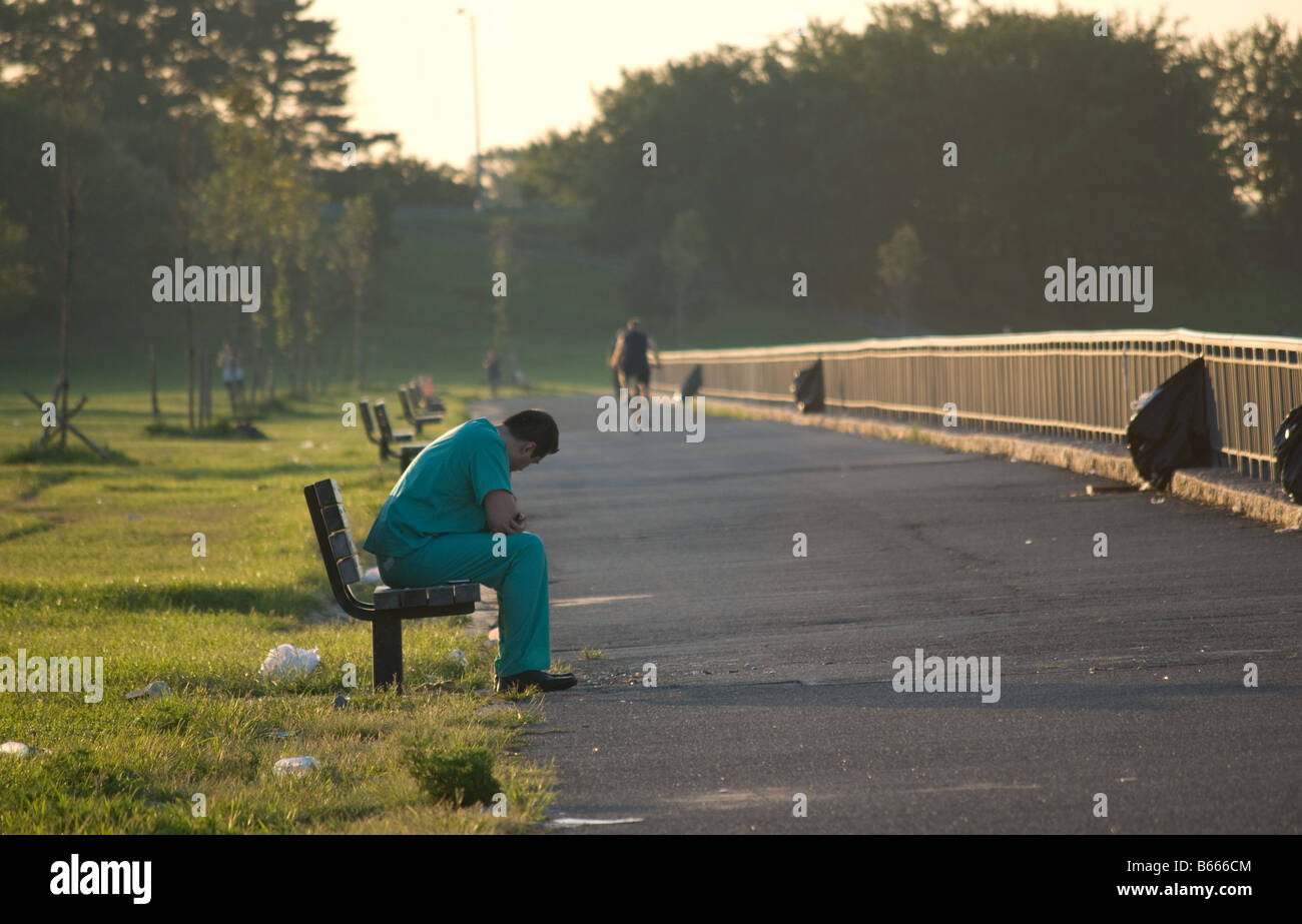 A medical doctor sitting on bench in a park Stock Photo - Alamy