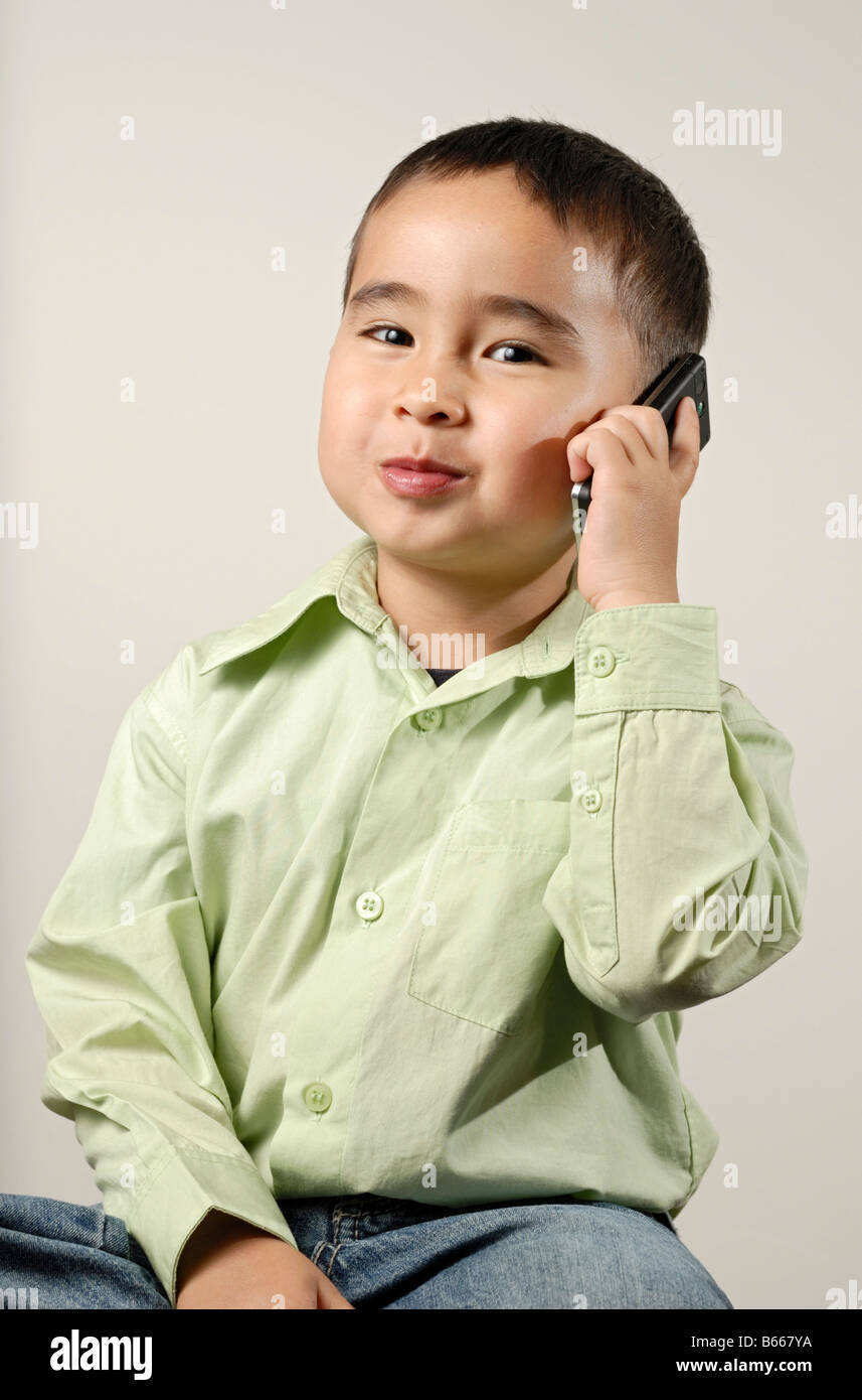 A young cute boy talking on phone Stock Photo - Alamy