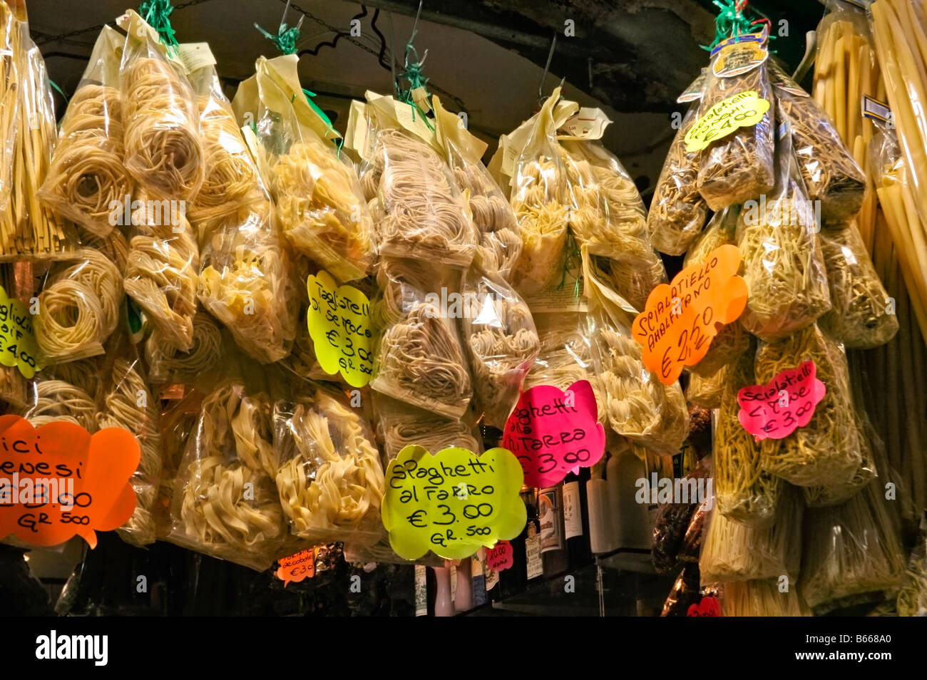 Bags of dried Italian pasta, from durum wheat, hanging in a shop in ...