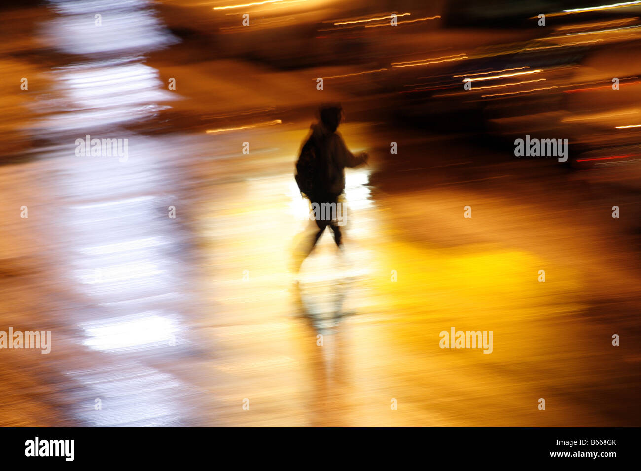 person walking in heavy rain at night in town Stock Photo - Alamy