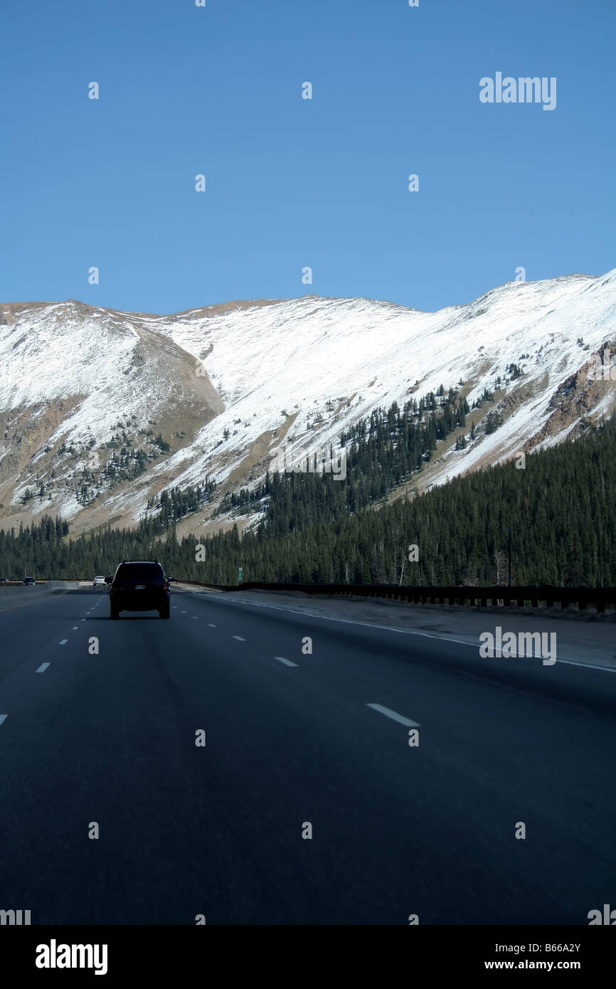 A suv driving on a colorado snow capped mountain Highway Stock Photo ...