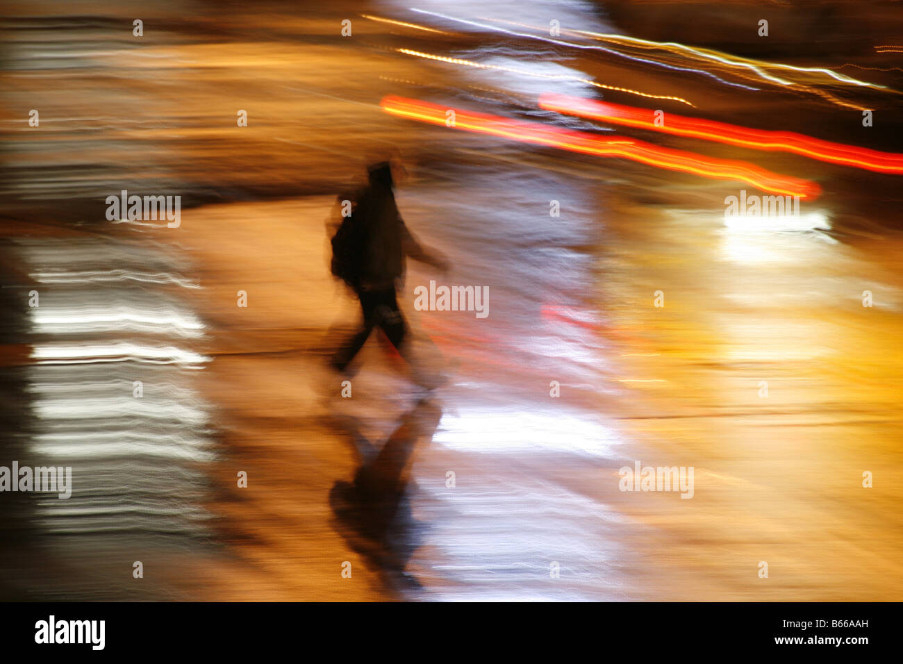 person walking in heavy rain at night in town Stock Photo - Alamy