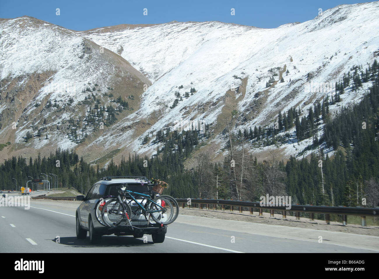 A suv driving on a colorado snow capped mountain Highway Stock Photo ...