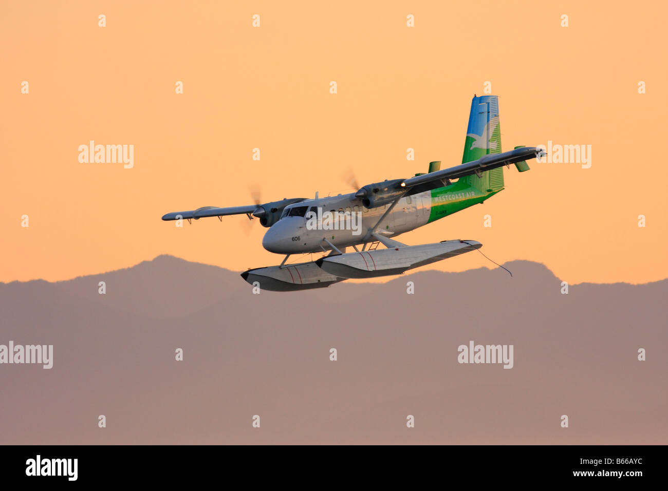 Commuter float plane preparing to land in harbour with Olympic ...