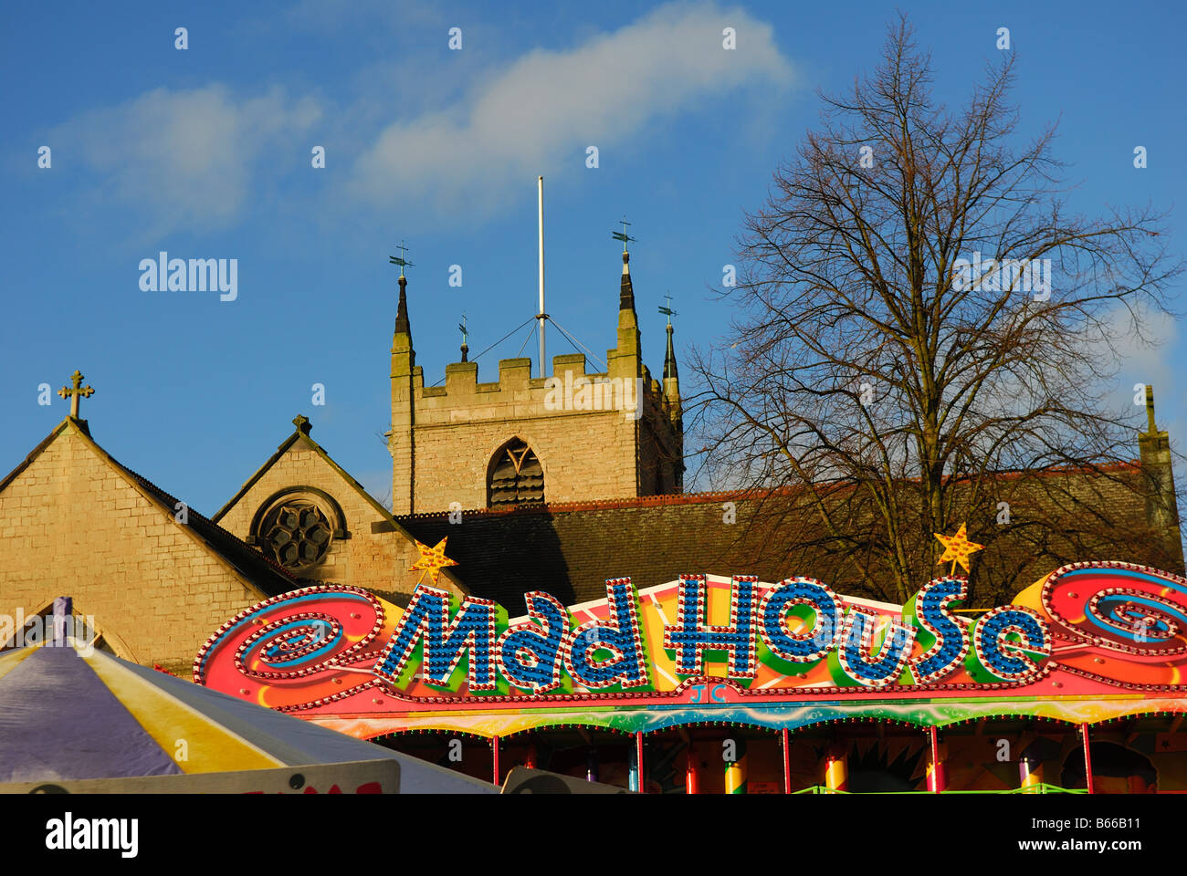 Church with funfair sign''mad house'' Stock Photo - Alamy