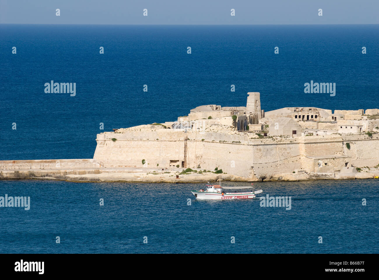 Fort Ricasoli and tourist cruising boat in Grand Harbour, from Upper ...