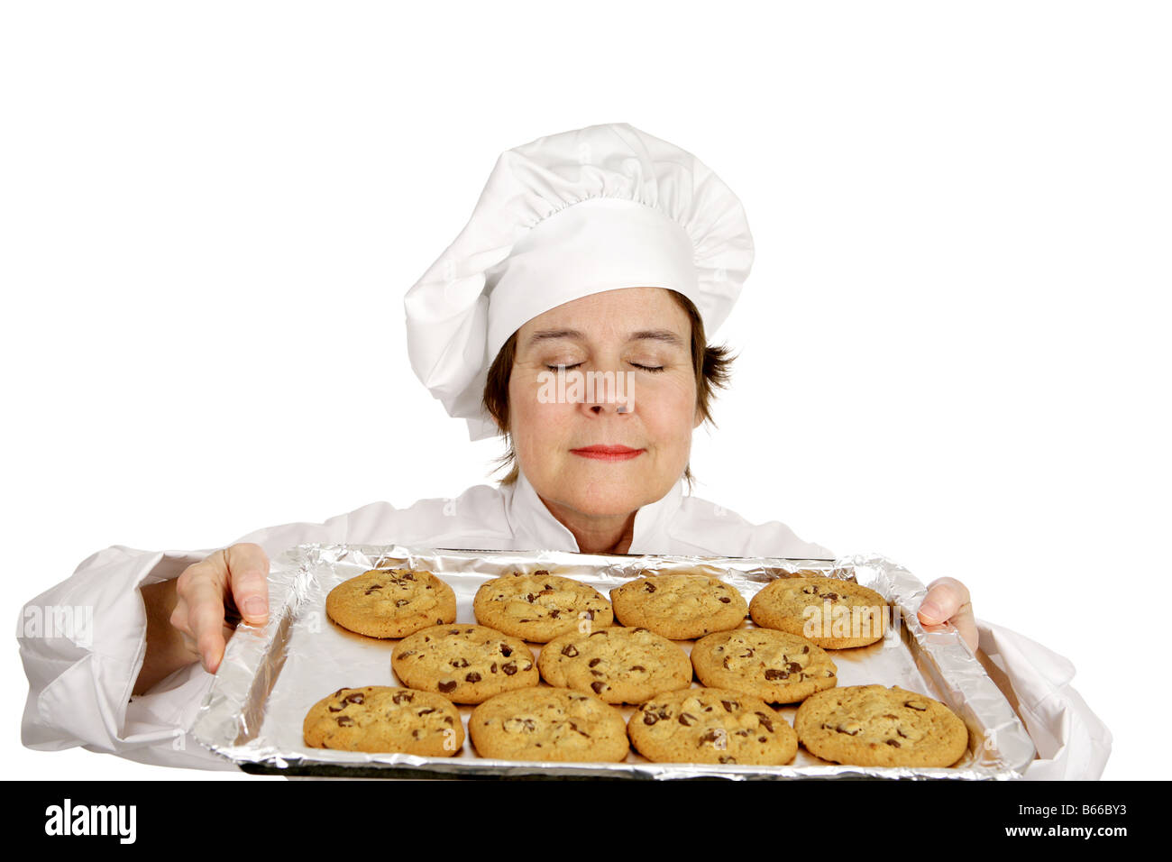 Chef smelling the aroma of a freshly baked batch of chocolate chip ...