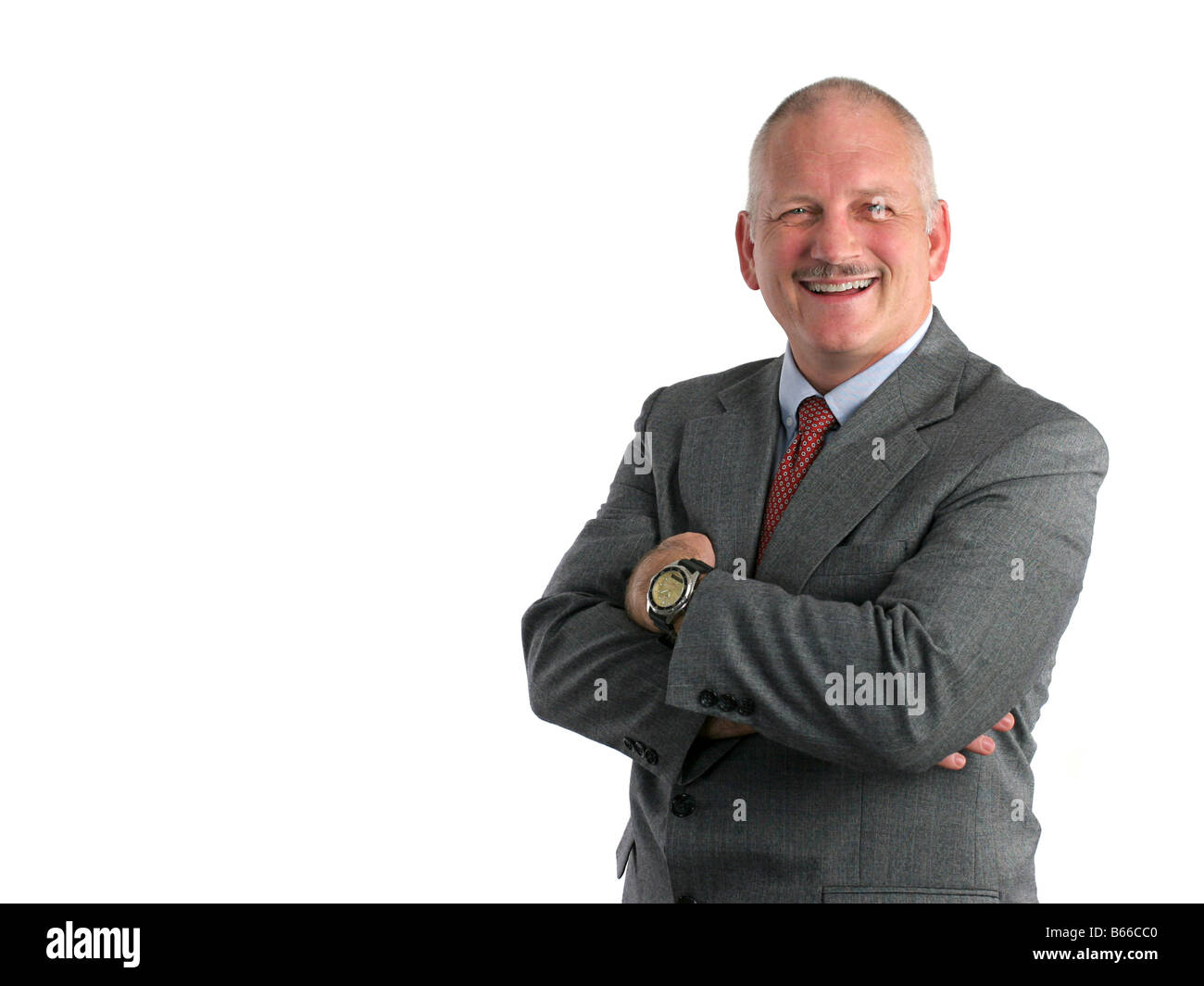 a friendly looking man in a suit with his arms crossed room for text ...