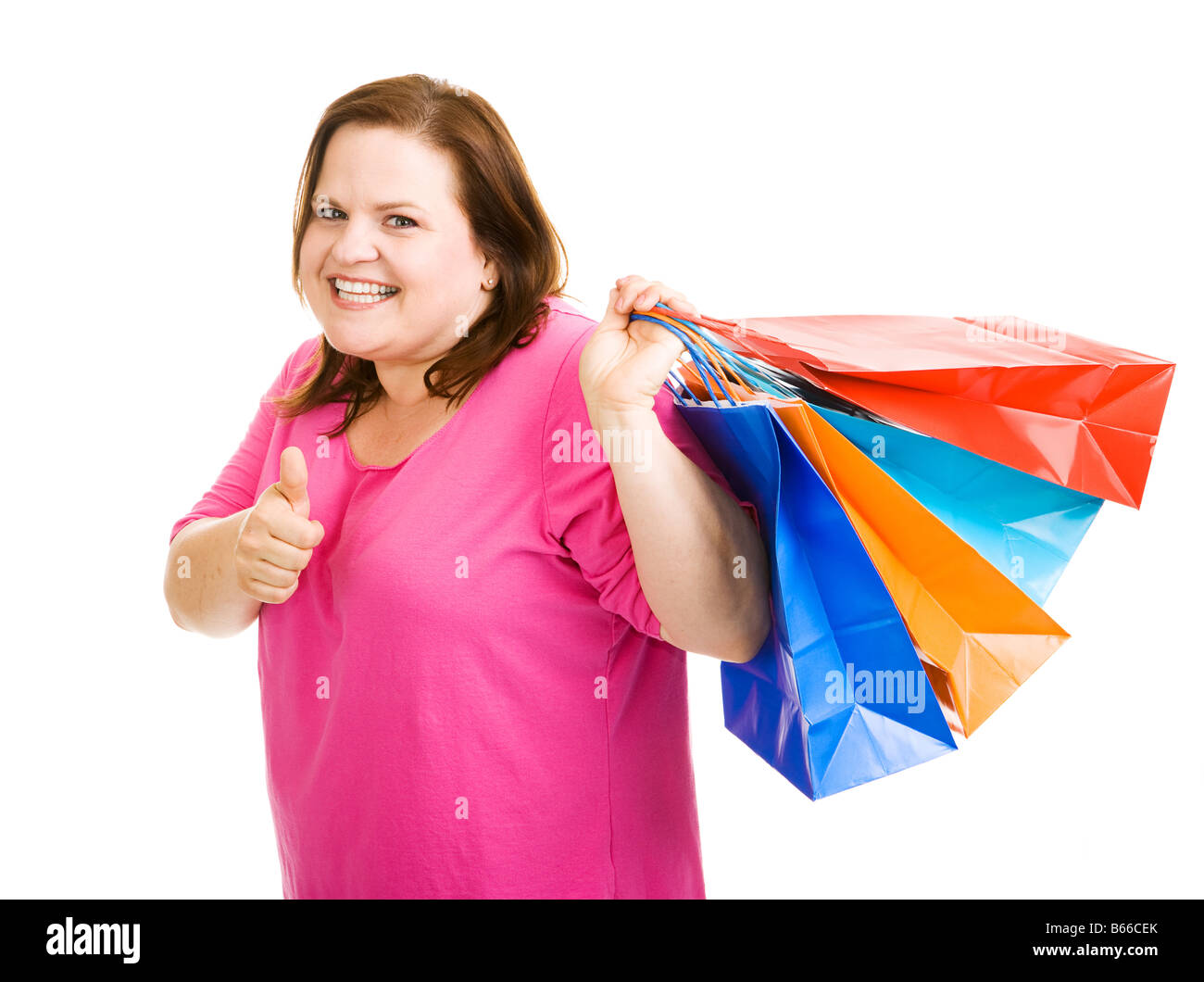 Pretty plus sized shopper holding her shopping bags and giving a thumbs ...