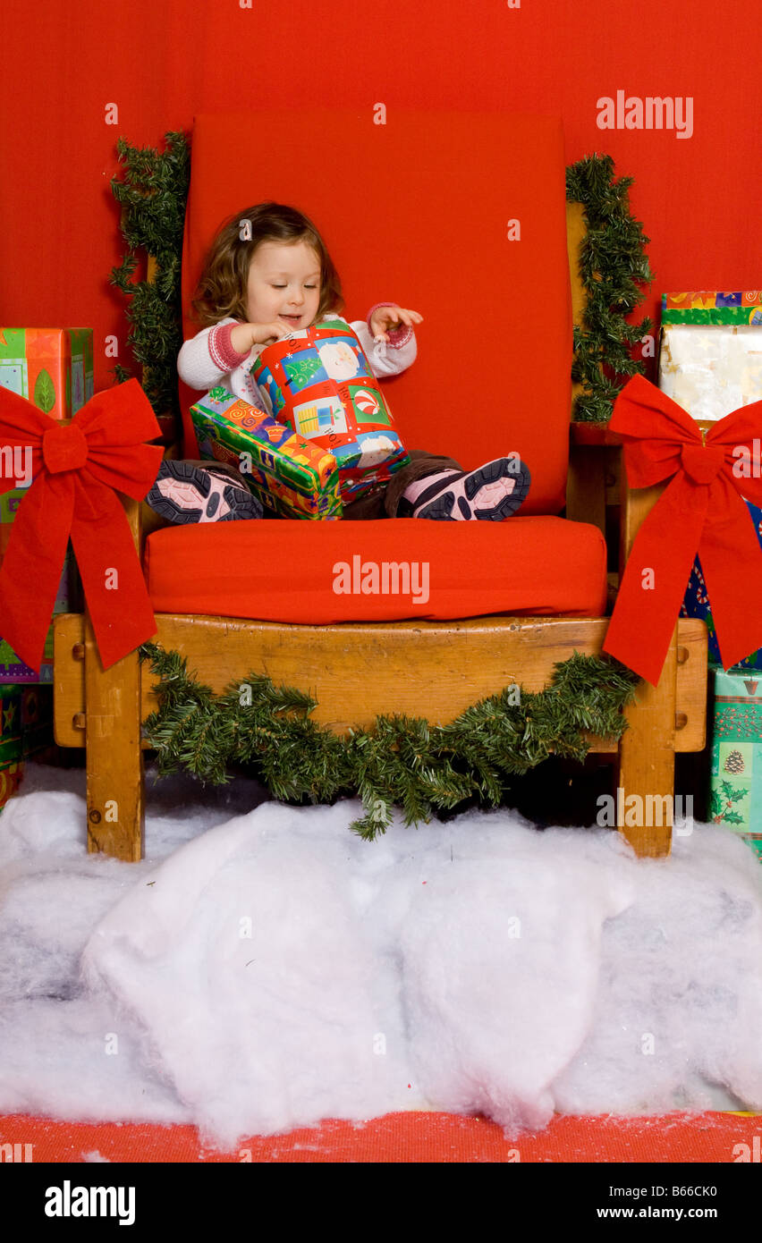 2 Year Old Little Girl Unwrapping Her Christmas Gift On Santa s Throne Stock Photo Alamy 2-year-old-little-girl-unwrapping-her-christmas-gift-on-santa-s-throne-stock-photo-alamy
