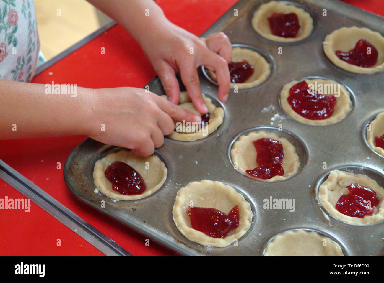Child making jam tarts Stock Photo - Alamy