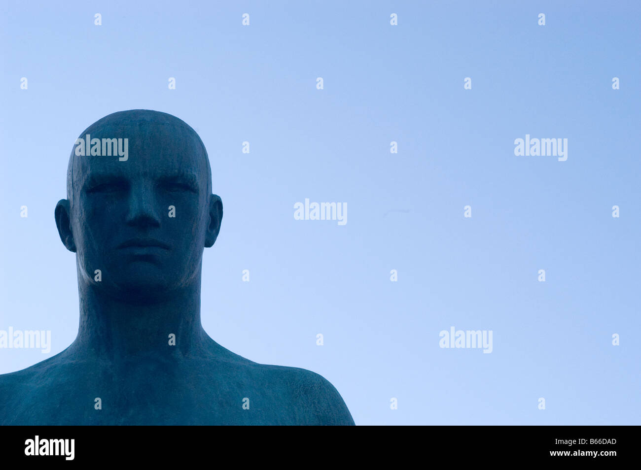 The head of a human statue against a blue sky background Stock Photo ...