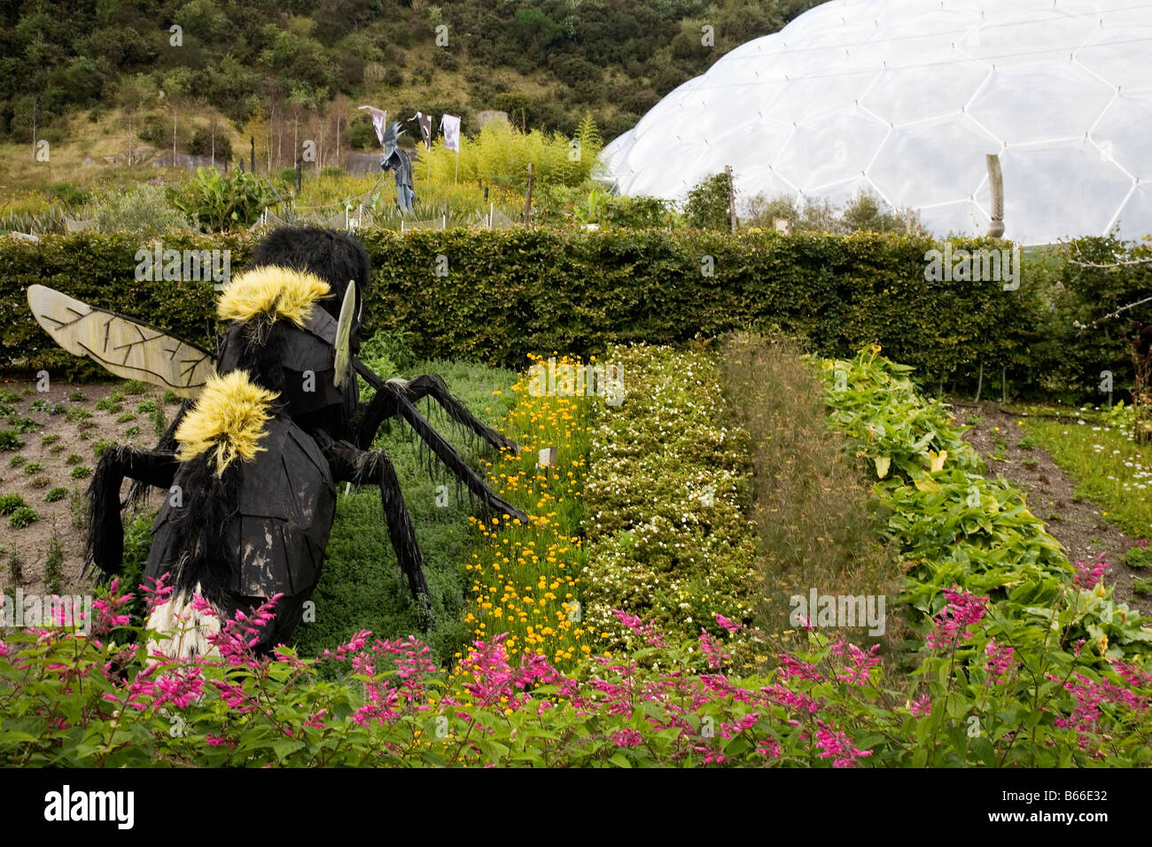 The gardens at Eden Project Cornwall with a large modern sculpture of ...