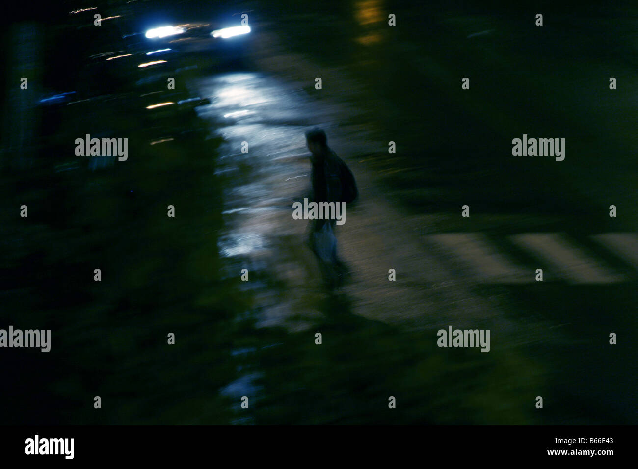 person walking in heavy rain at night in town Stock Photo - Alamy