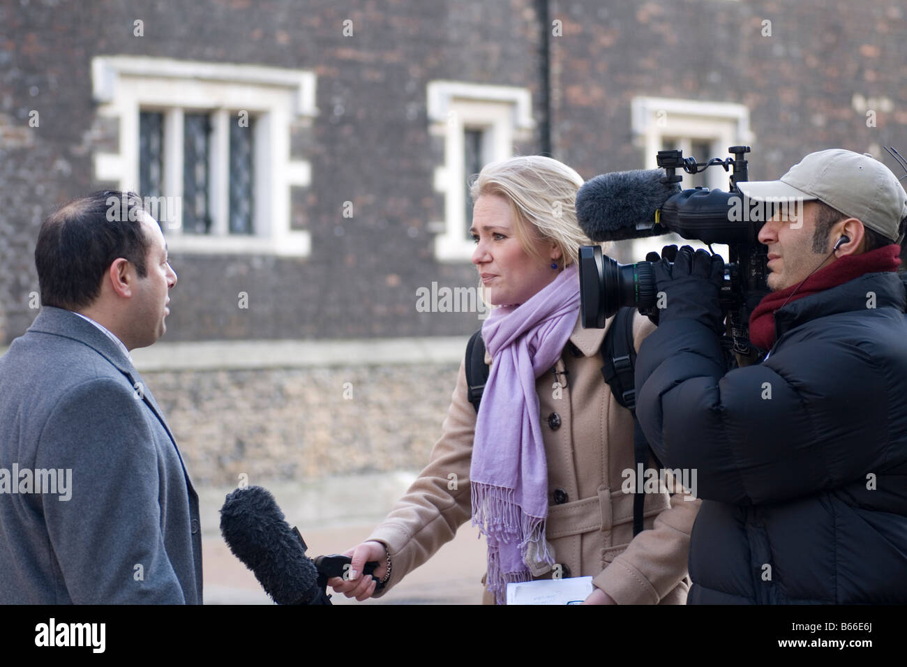 A film crew interviews a member of public in the street in Croydon ...