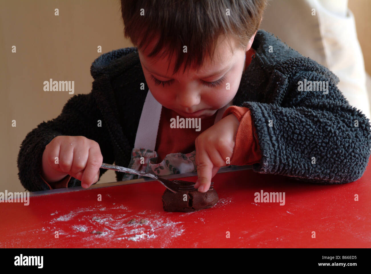 Boy making chocolate biscuits cookies at nursery Stock Photo - Alamy