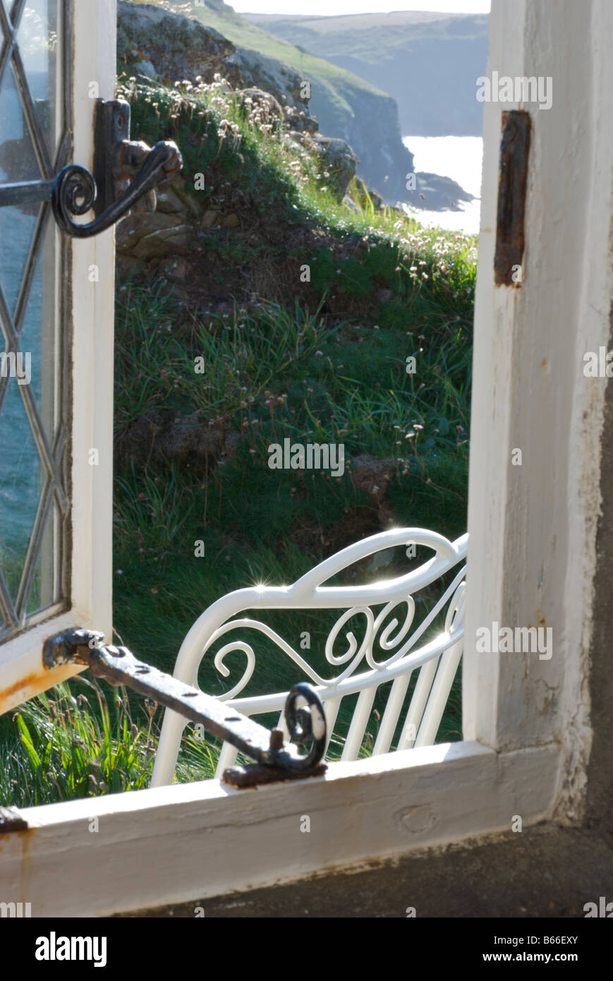 Looking through an open window of Doyden Castle onto a view of the ...