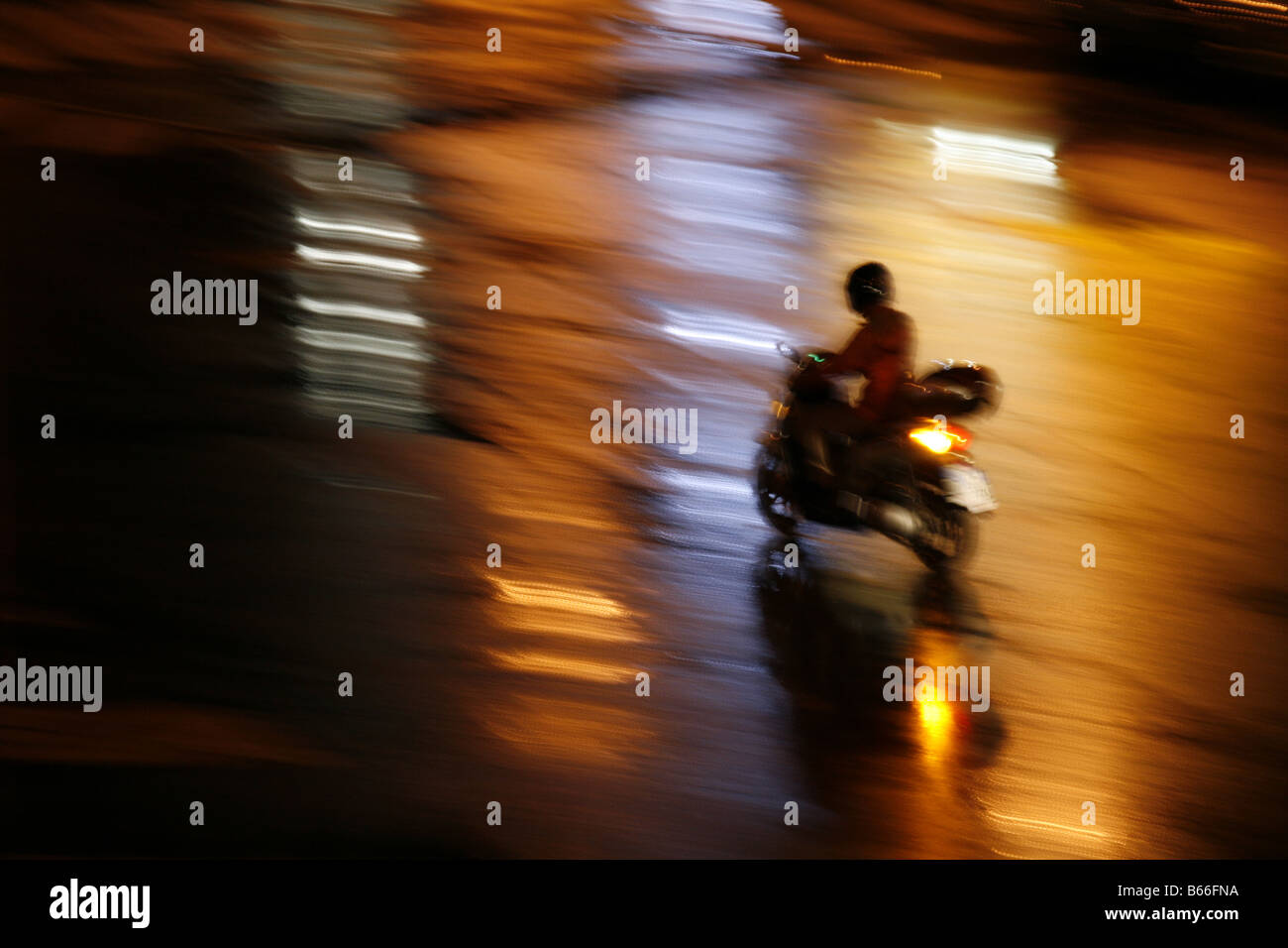 fast motorbike rider heavy rain at night in town Stock Photo - Alamy