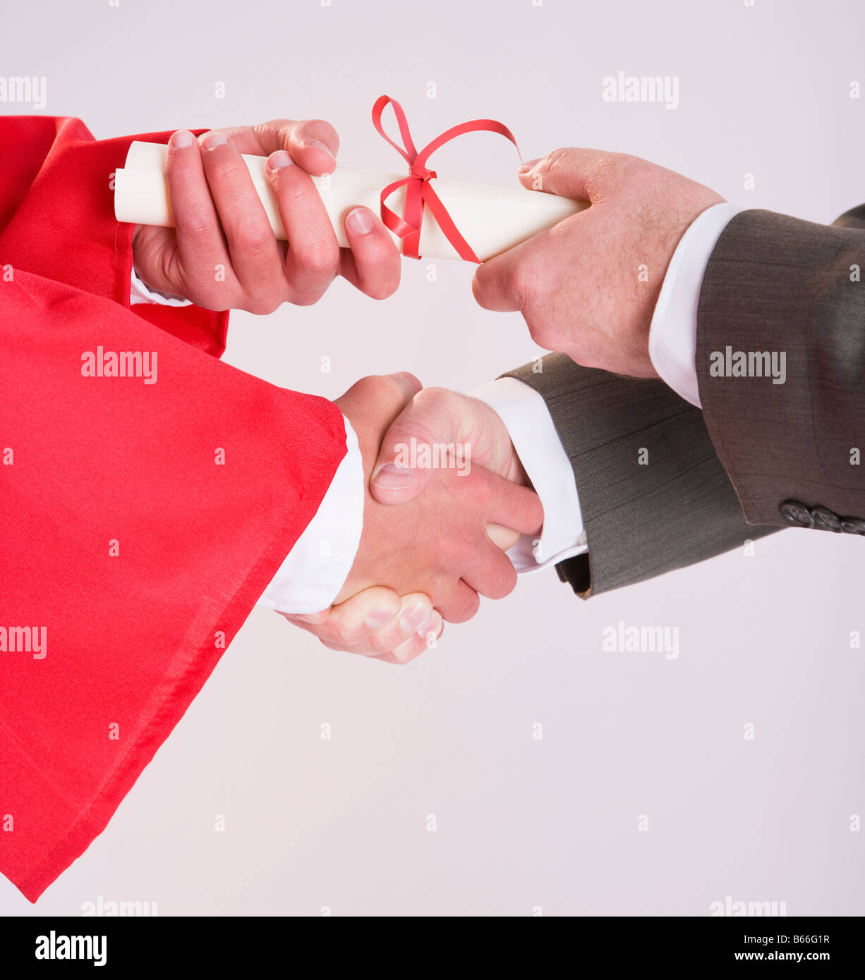 Professor handing diploma to graduate, close-up Stock Photo - Alamy