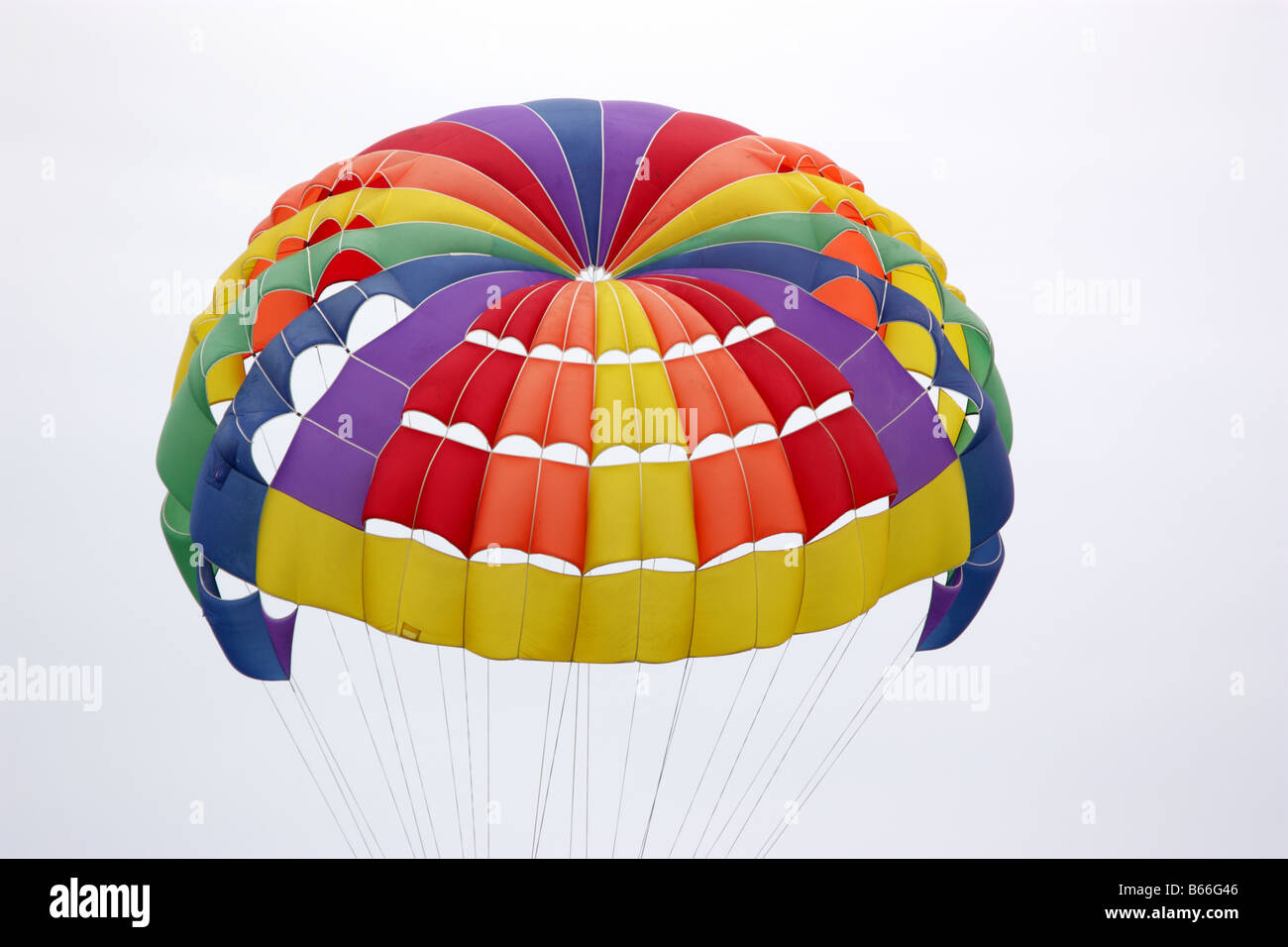 MULTICOLOURED PARACHUTE USED FOR PARASAILING WHITE BACKGROUND ...