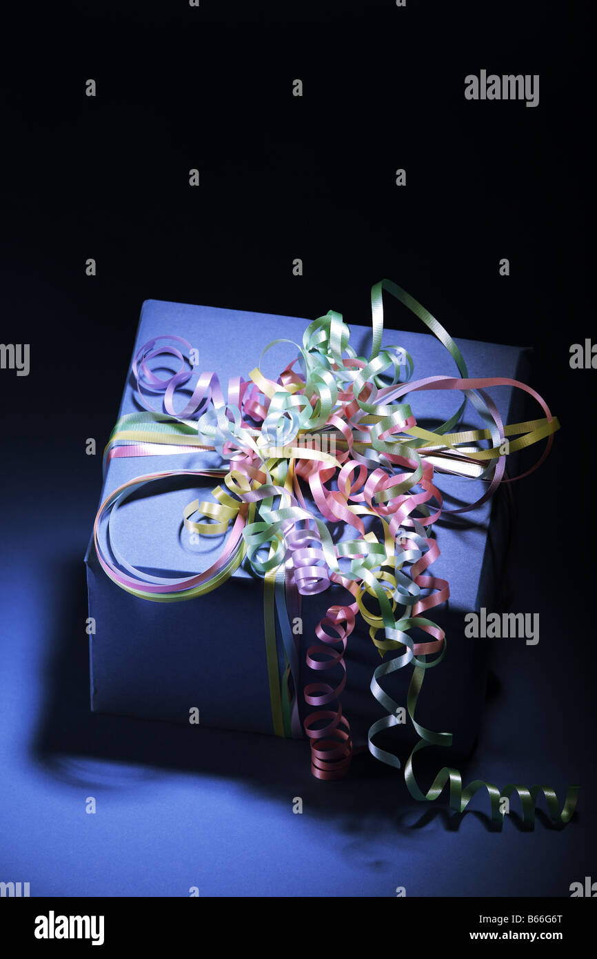 Blue gift wrapped present with colorful ribbons Stock Photo - Alamy