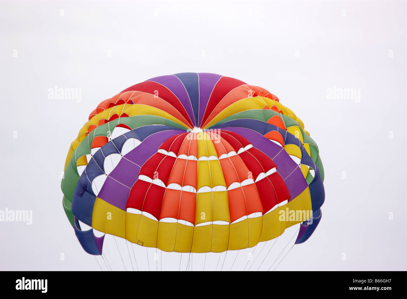 MULTICOLOURED PARACHUTE USED FOR PARASAILING WHITE BACKGROUND ...