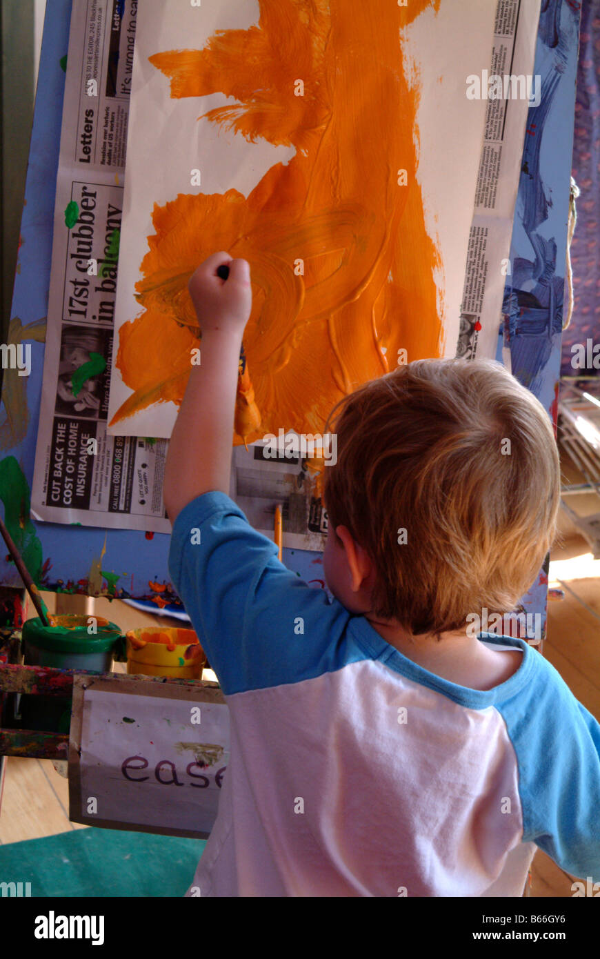 Back view of a child painting at nursery school Stock Photo - Alamy