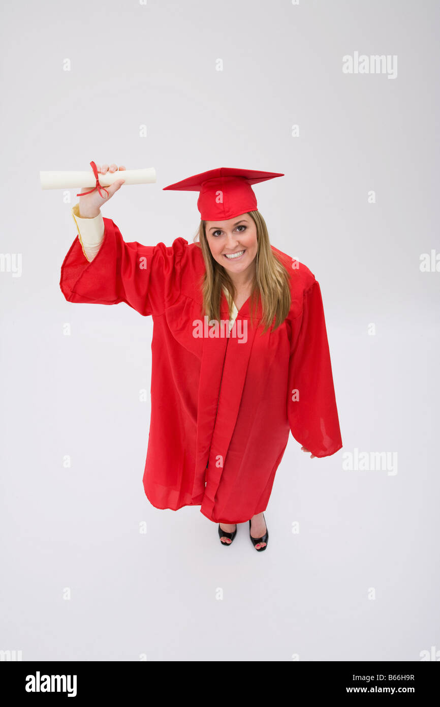 Studio portrait of female graduate in red gown Stock Photo - Alamy