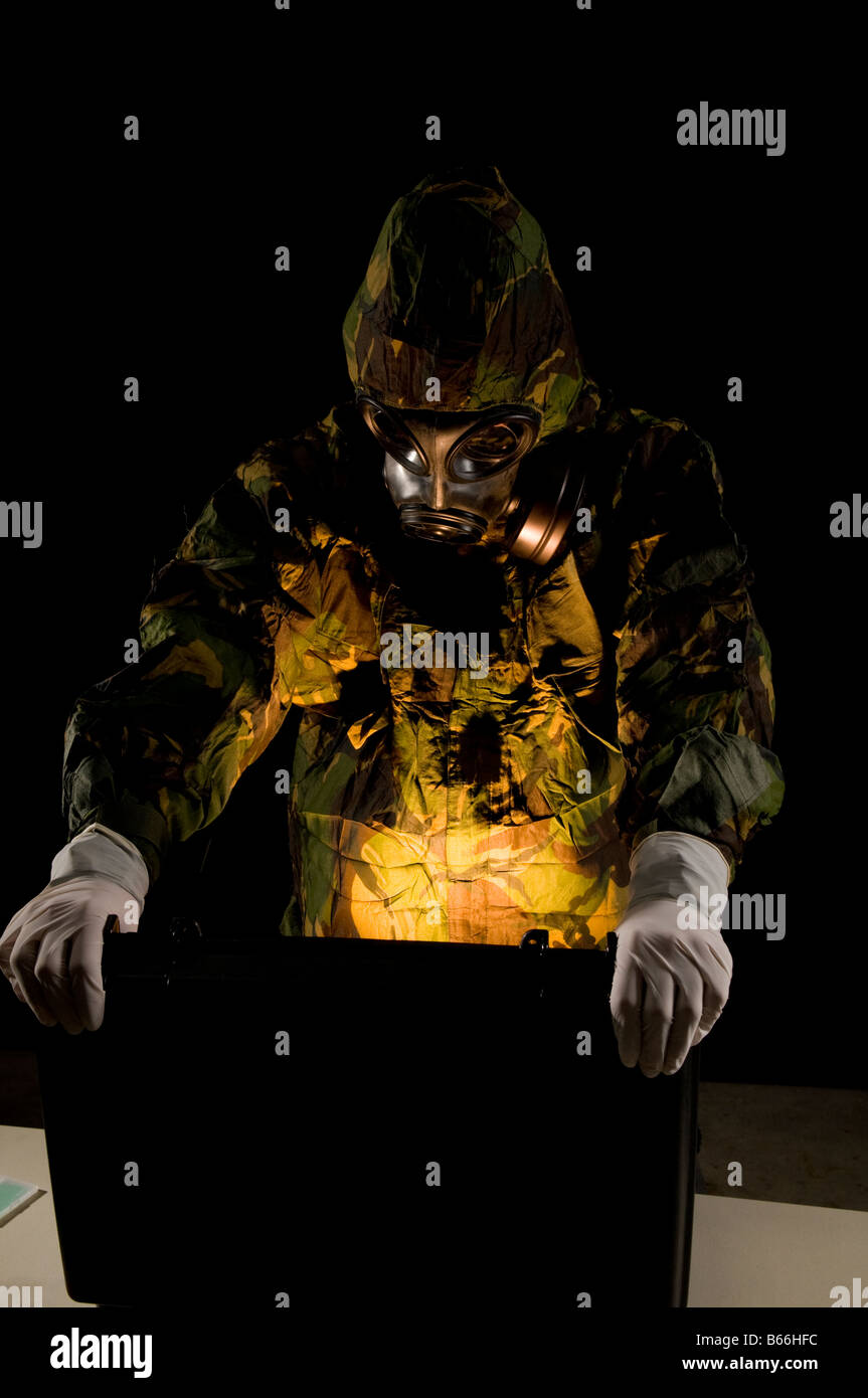 Soldier in protective suit opens case with glowing substance inside ...