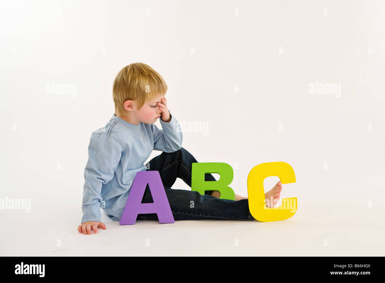little boy overwhelmed by ABCs Stock Photo - Alamy