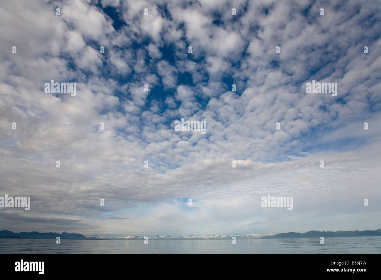 USA Alaska Morning sun lights clouds above Frederick Sound Stock Photo ...