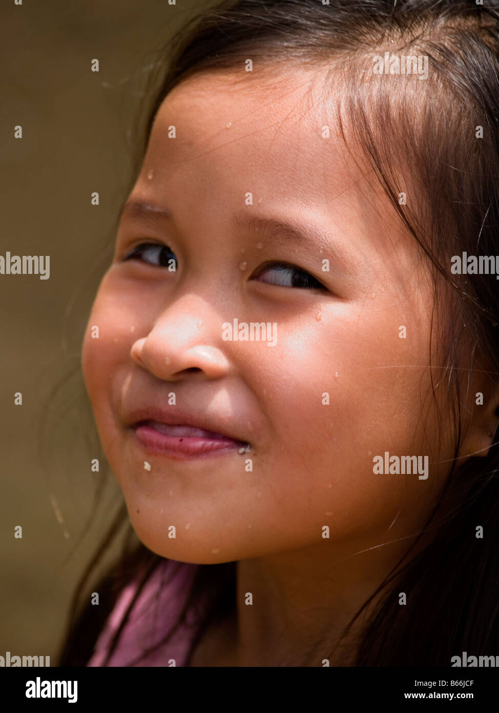 girl with mischievous face in Muang Ngoi village in northern Laos Stock ...